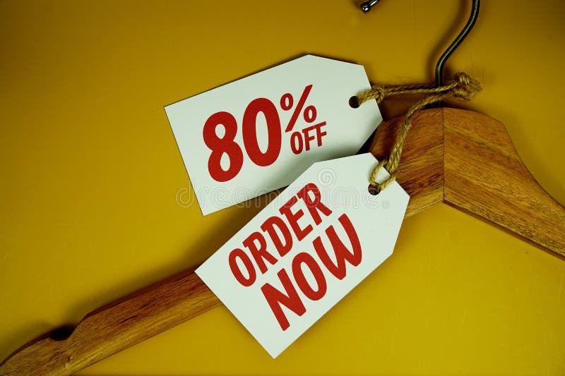 Order Now and Sale 80 on Price Tag with Wooden Clothes Hanger on Yellow ...