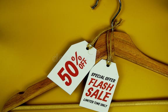 Order Now and Sale 50 with Wooden Clothes Hanger on Yellow Background ...