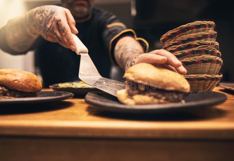 Order Up. Closeup of a Unrecognisable Chefs Tattooed Hands Serving Up a ...