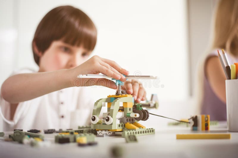 Focused Child Making Toy in Class Stock Image - Image of overstrict ...