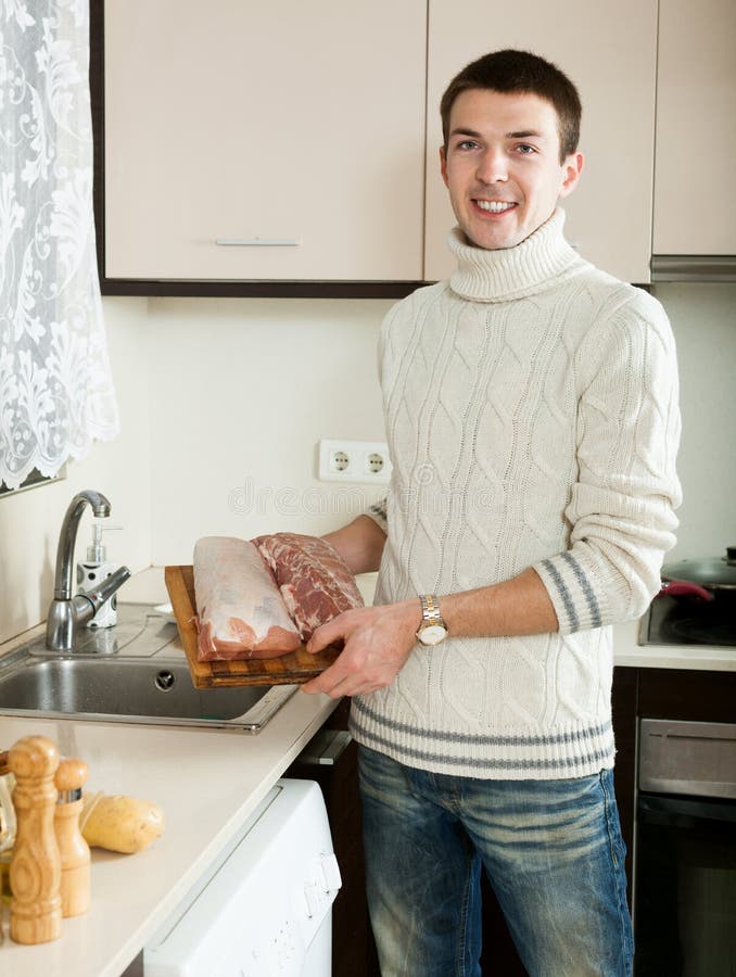 Ordinary guy cooking meat stock image. Image of preparation - 39178779