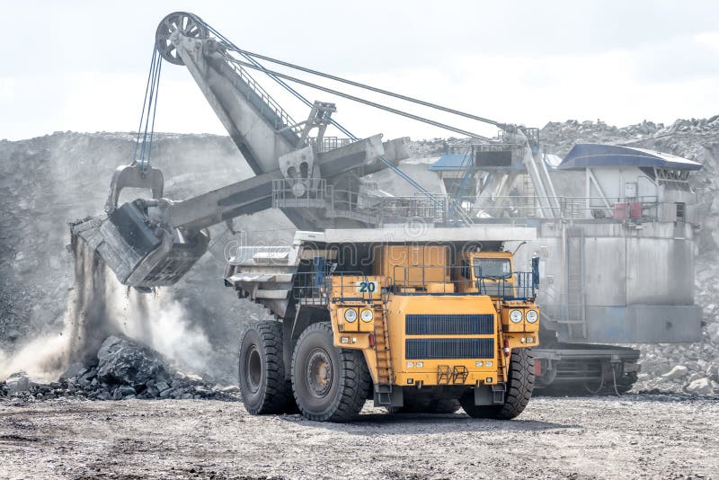 Ore Loading with a Powerful Excavator. Loading a Large Mining Truck ...