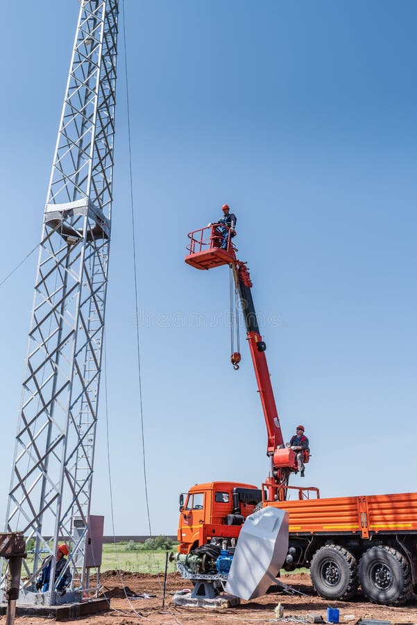 Workers at a Construction Site Install a Wind Generator from Aerial ...
