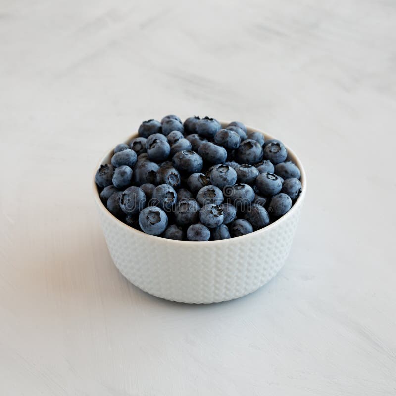 Organic Blueberries in a Bowl on a Gray Background, Side View Stock ...
