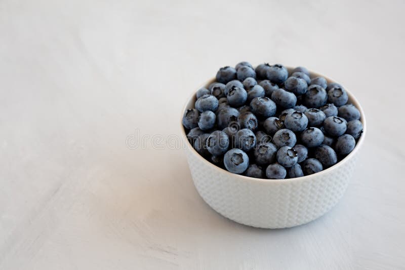 Organic Blueberries in a Bowl on a Gray Background, Side View. Copy ...