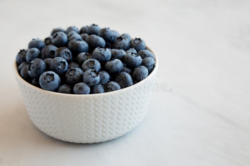 Organic Blueberries in a Bowl on a Gray Background, Side View. Space ...