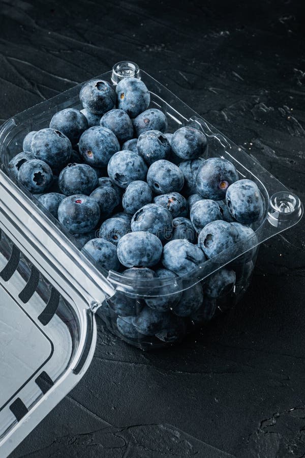 Organic Blueberries in Plastic Box Package, on Black Background Stock ...