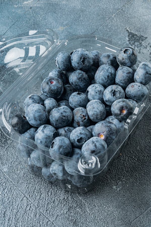 Organic Blueberries in Plastic Box Package, on Gray Background Stock ...