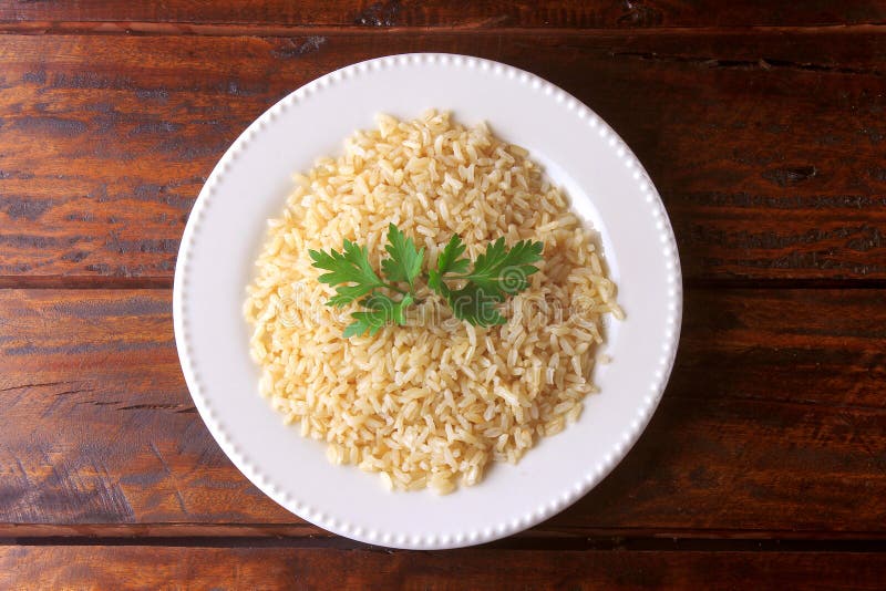 Organic Brown Rice Grain Cooked in White Dish on Rustic Wooden Table ...