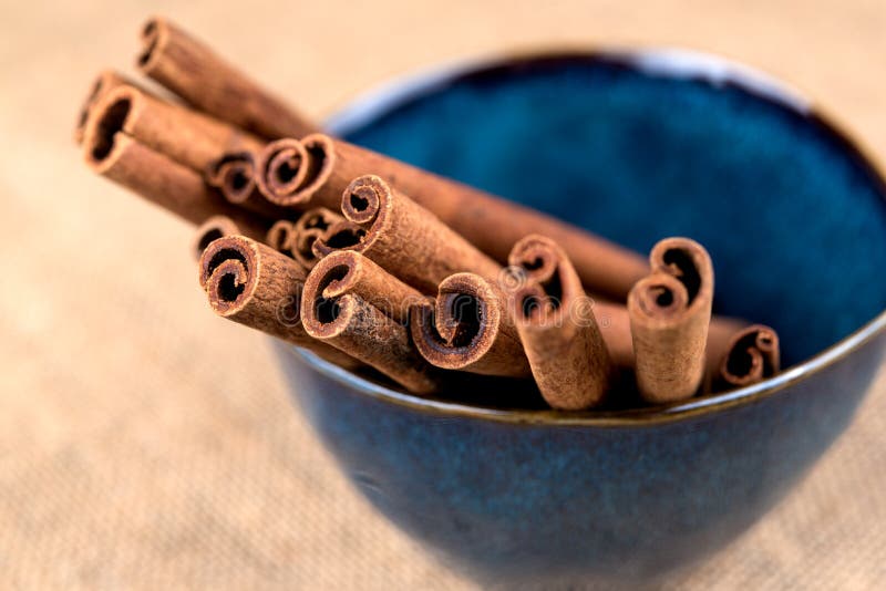 Organic Cinnamon Sticks and a Blue Bowl Stock Photo - Image of stacked ...