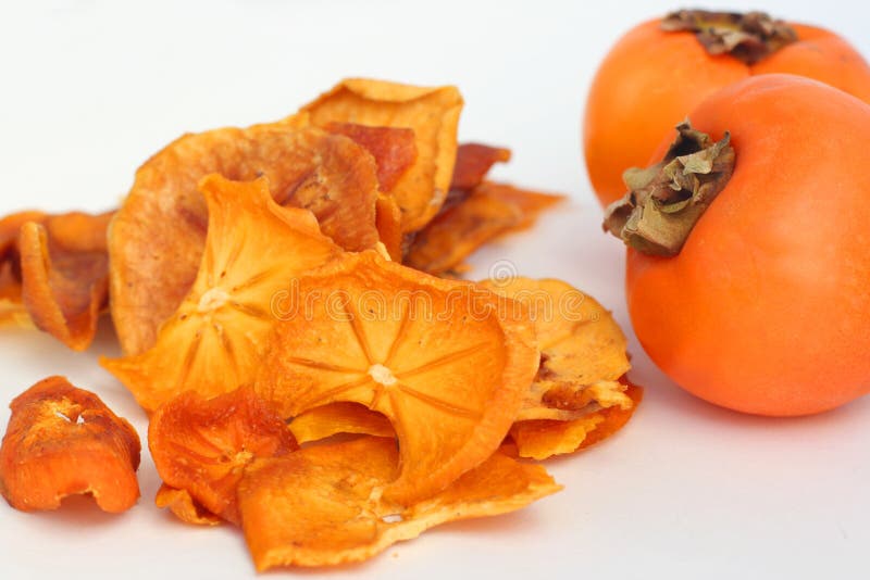 Dried Persimmon with Powdered Sugar Lies on a Stone Dish, on a Dark ...