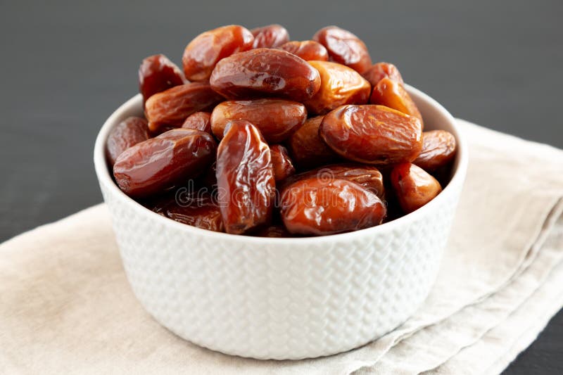 Organic Dry Deglet Nour Dates in a Bowl, Side View. Close-up Stock ...