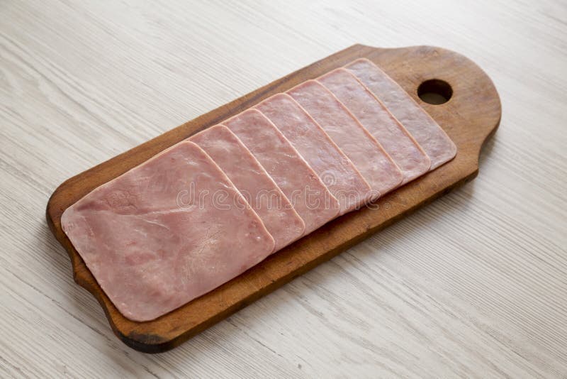 Organic Jamon Cocido Extra on a Rustic Wooden Board on a White Wooden ...