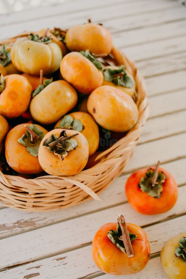 Organic Khakis Fruit in a Wicker Basket. Persimmons Stock Photo - Image ...