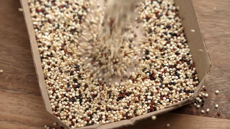 Organic Mixed Uncooked Quinoa Grains Falling into a Cardboard Packaging ...