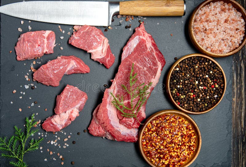 Organic Raw Meat, Beef or Lamb on Dark Stone and Spices. Top View Stock ...