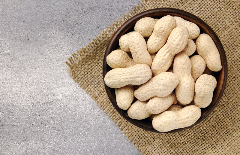 Organic Raw Peanuts in a Bowl on Grey Table Stock Photo - Image of ...