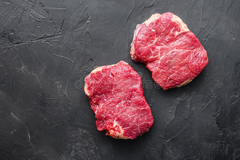 Set of Raw Rump Steaks Over Black Textured Background, Top View Stock ...