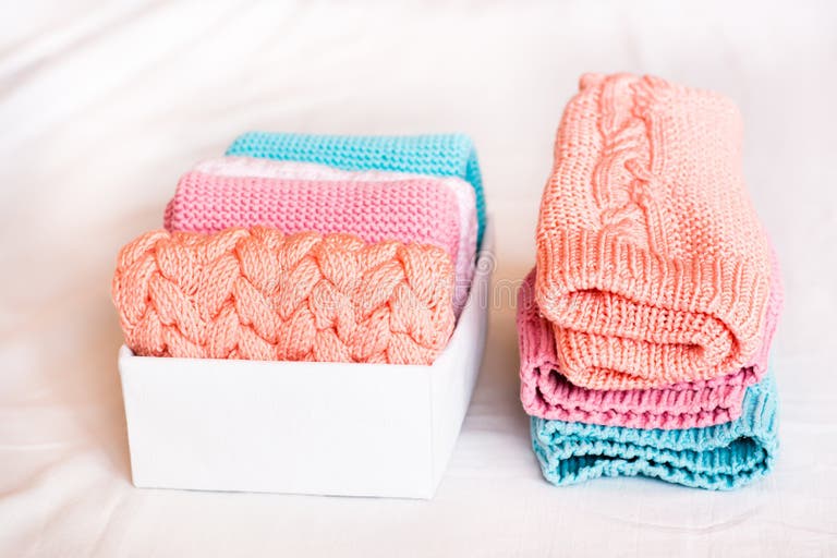 Organization and Order. a Stack of Knitted Clothes Next To a Box of ...