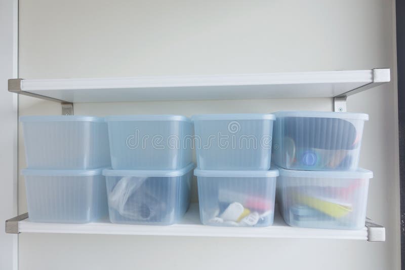 Organization of Storage Containers on a White Shelf in a Tidy Space ...