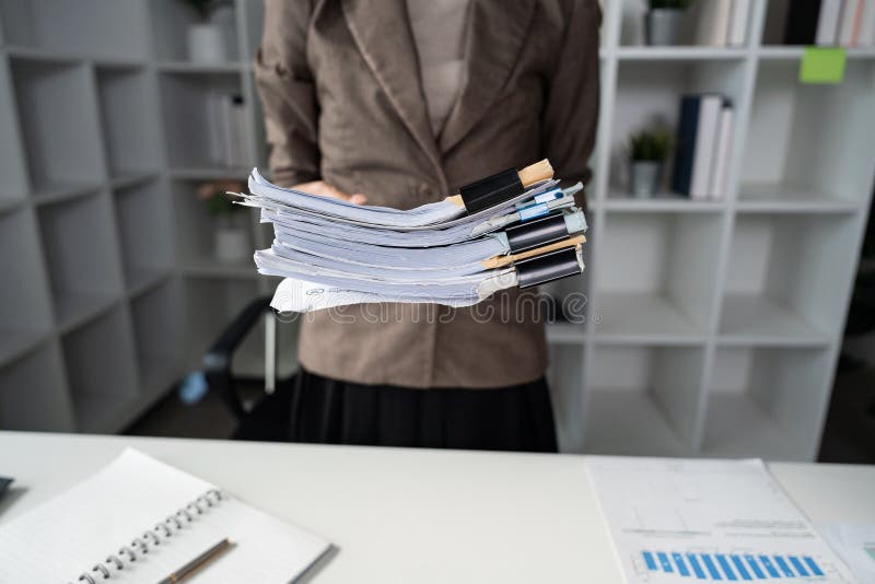 Organized Businesswoman Presenting a Stack of Financial Documents in a ...