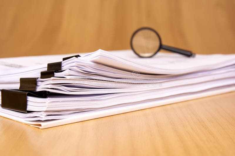 Organized Documents with a Magnifying Glass for Thorough Inspection and ...