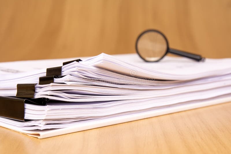 Organized Documents with a Magnifying Glass for Thorough Inspection and ...