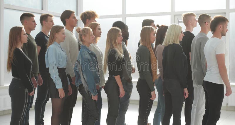 Organized Group of Casual Young People Standing in a Column Stock Image ...