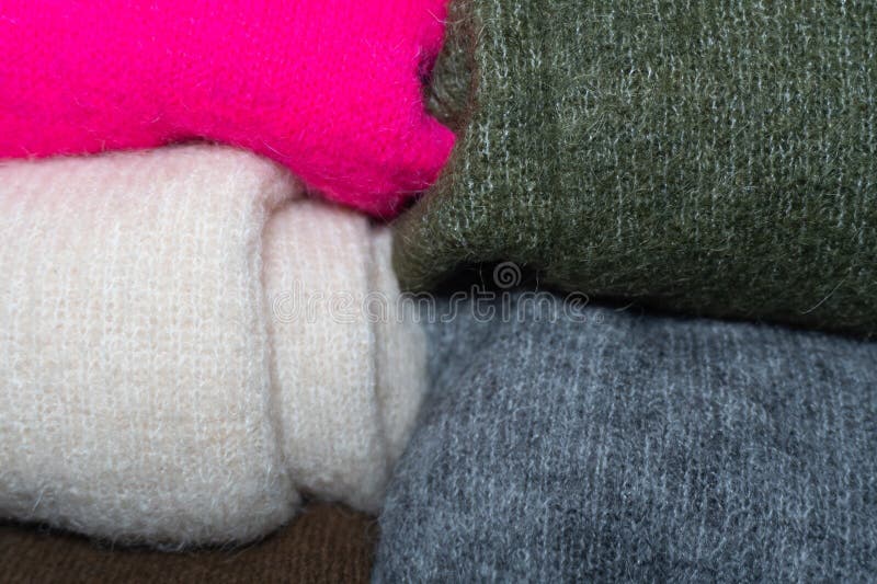 Organized Layers of Woolen Clothes in Various Colors—pink, Green, Beige ...