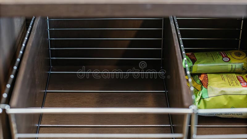 Organized Pantry with Empty Wire Shelves and Packed Dried Food Stock ...