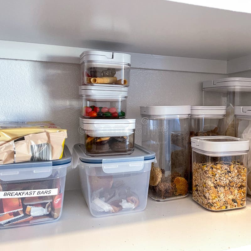 An Organized Pantry Shelf with Various Types of Cookies Cereal and ...