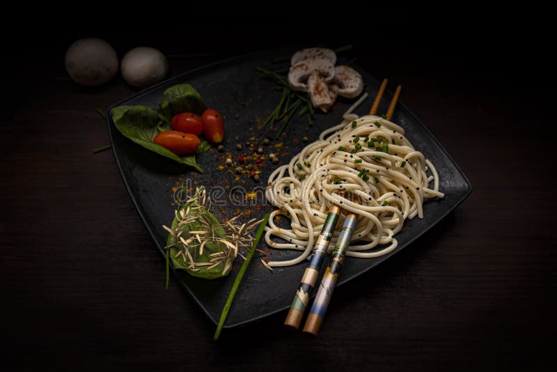Oriental pasta black dish stock image. Image of mushroom - 153609377