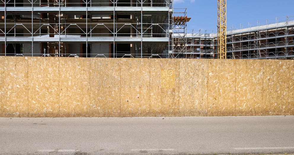 Oriented Stranded Board Barrier with Large Building Under Construction ...