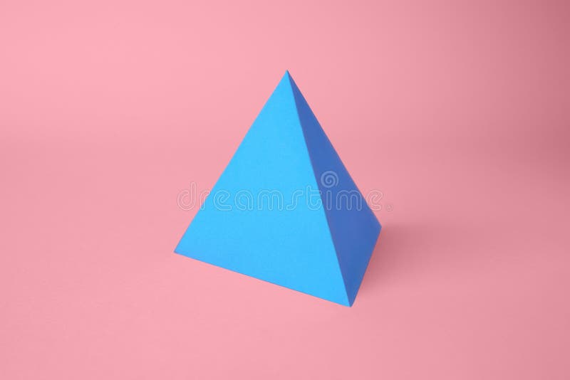Origami Art. Paper Pyramid on Pink Background Stock Photo - Image of ...