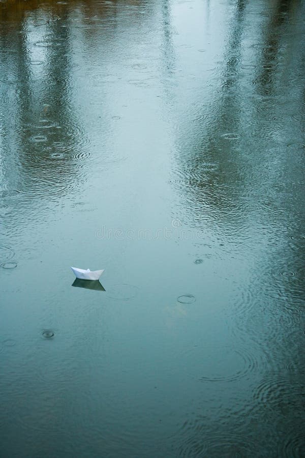 Origami Boat on Wet Asphalt during Rain Stock Image - Image of ...