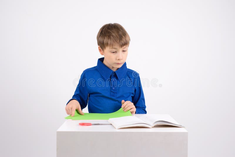 Origami: a Boy Learns in the Book To Make Crafts Out of Paper Stock ...