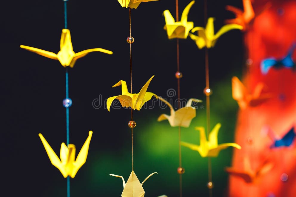 Origami from Colored Paper in the Form of Cranes Hanging on a St Stock ...
