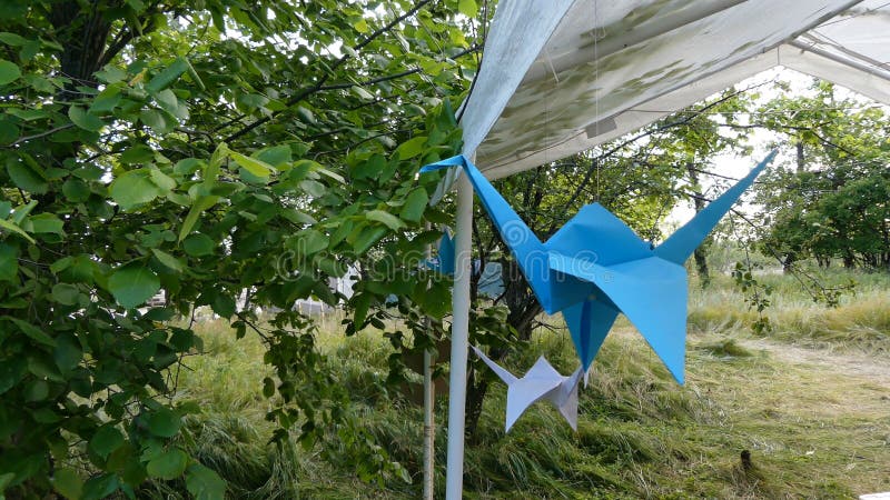 Origami Crane Hanging on a Thread. Decorating a Tent in Nature Stock ...