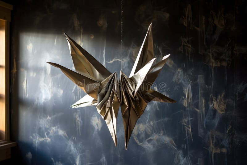 An Origami Crane Mobile Casting Soft Shadows on a Wall Stock ...