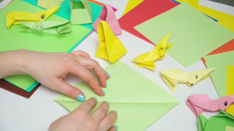 Origami Folding Figures of Easter Bunnies from Paper, Hands Close-up ...