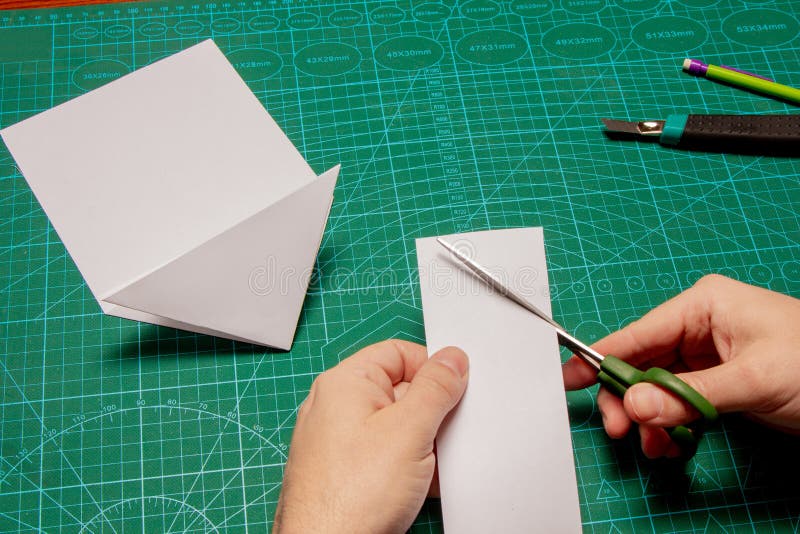 Origami Project on White Paper with Cutter and Scissors Stock Photo ...