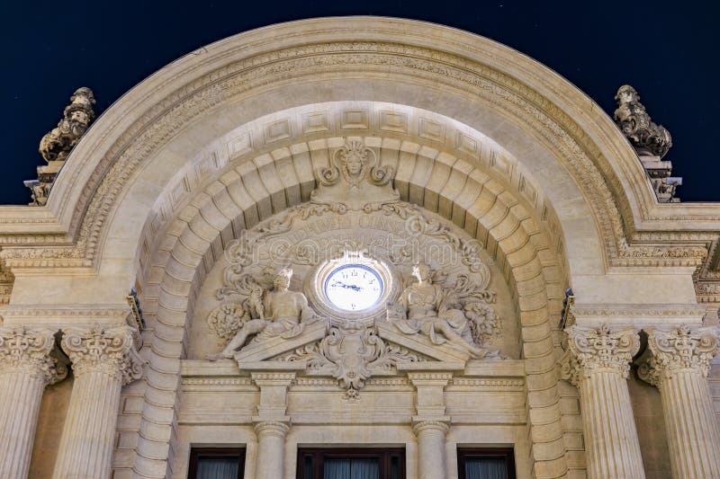 Ornate Architectural Facade with Clock and Sculptures Under Night Sky ...
