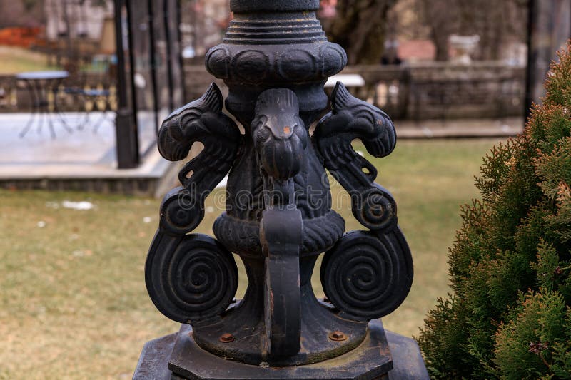 Ornate Black Metal Sculpture of Mythical Creatures in Garden Setting ...