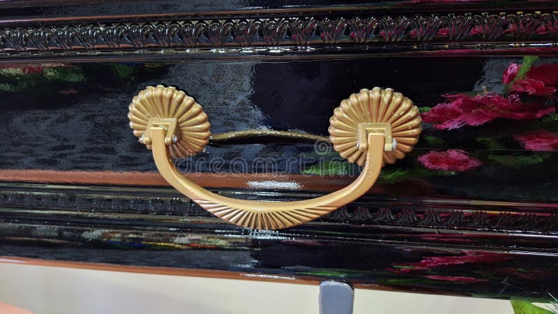Ornate Brass Handle on Black Coffin with Floral Accents Stock Photo ...