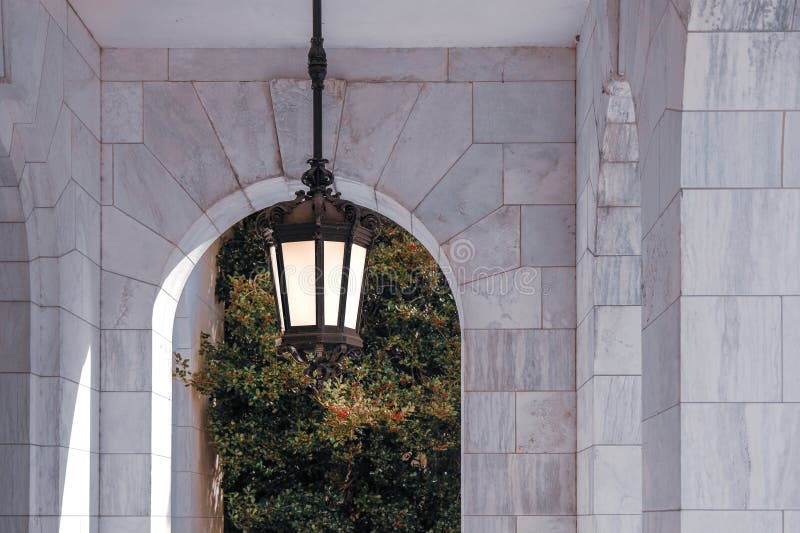 Ornate Hanging Light Fixture and Elegant Granite Tile at Arched ...