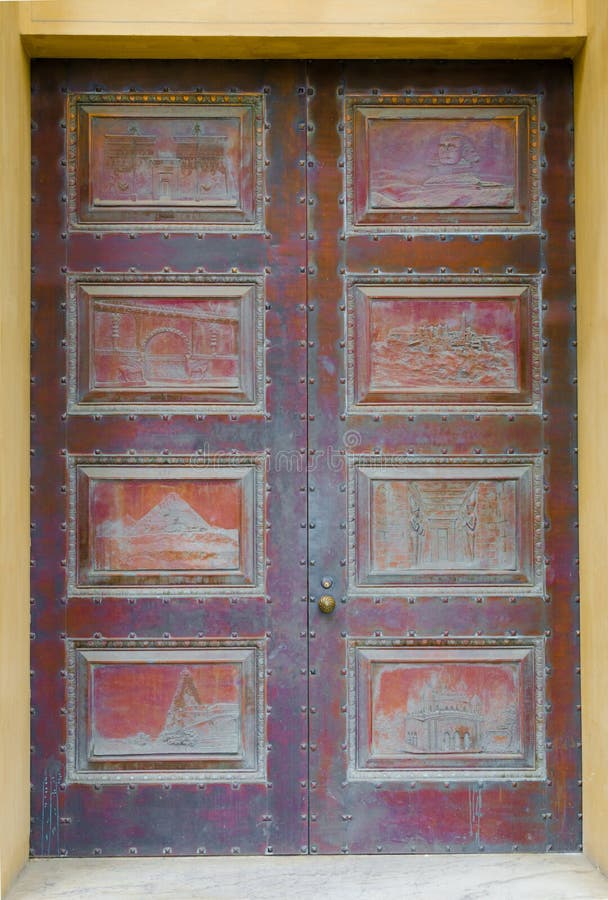 An Ornate Iron Door with Four Metal Panels on Each Side Embossed with ...