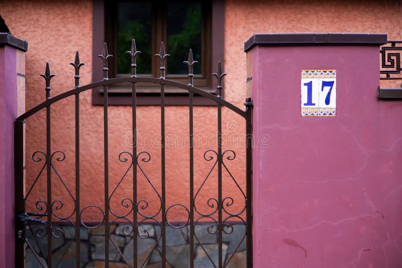 Ornate Iron Gate and Pink Wall with Number 17 in Spanish Style ...