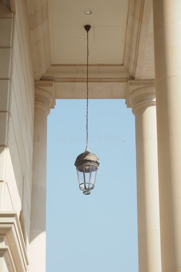 Ornate Lantern Hanging between Classic Columns in Bright Sunlight Stock ...