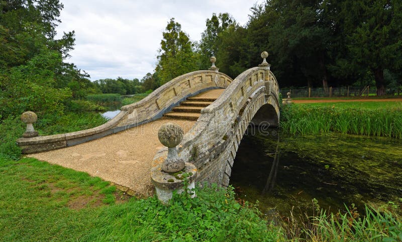 Ornimental Chinese Style Bridge Over Stream with Trees in Background ...
