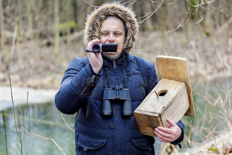 Ornithologist with Camcorder and Bird Cage Near River Stock Image ...